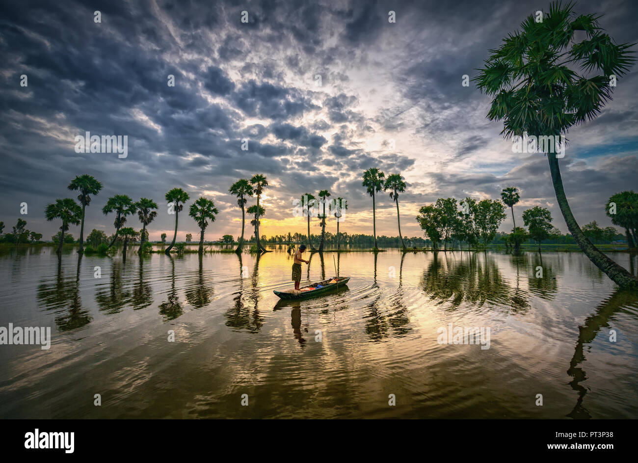 Unidentified fishers throw fish net to catch fish a lake in the morning ...