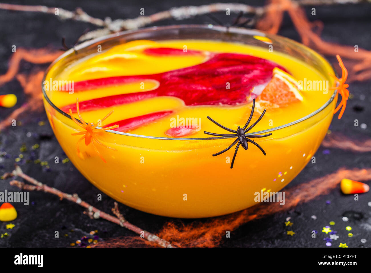 Ghoul's orange punch with bloody ice hand in a glass bowl on dark ...