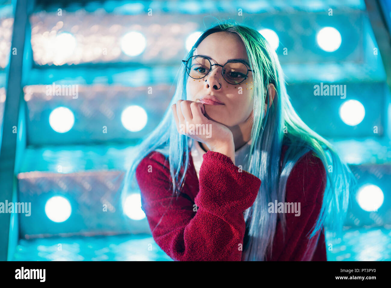 Hipster girl with blue dyed hair and sequins as freckles. Woman in red ...