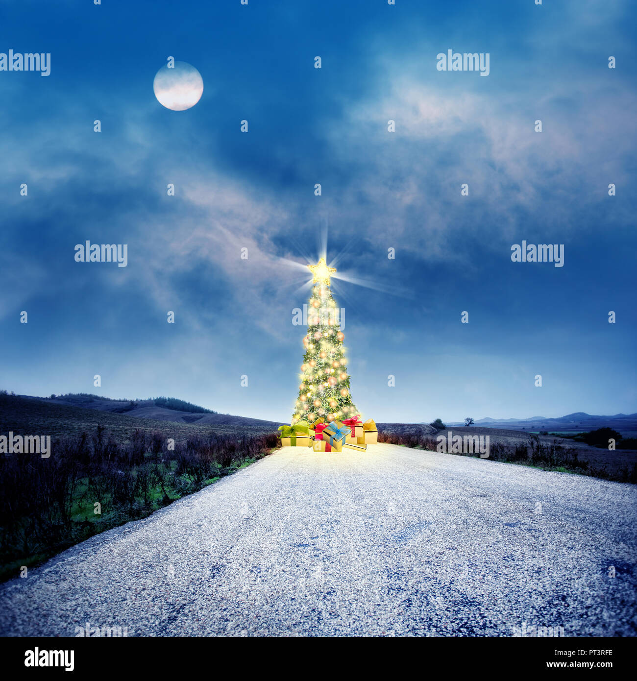 Conceptual image of road and decorated shiny Christmas tree over cloudy ...
