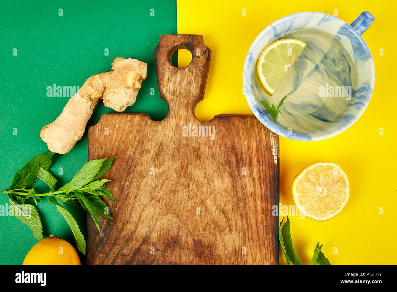 Ingredients for hot tea with ginger, lemon, mint and cups around ...