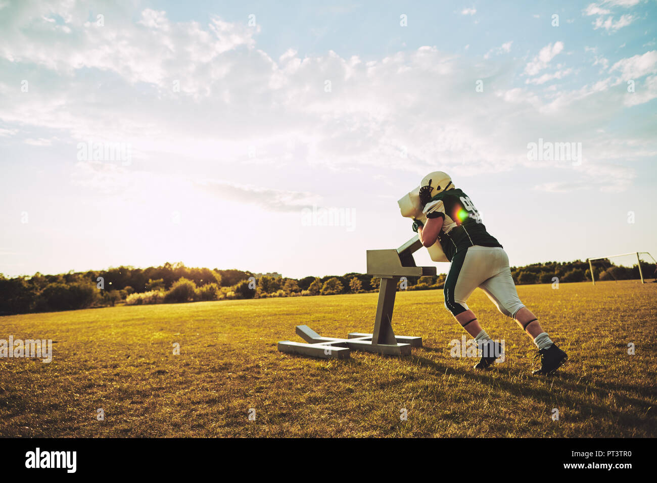 Young American football player doing defensive drills and practicing ...