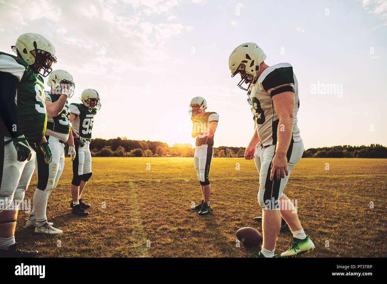 Group of young American football players lining up for a practice ...