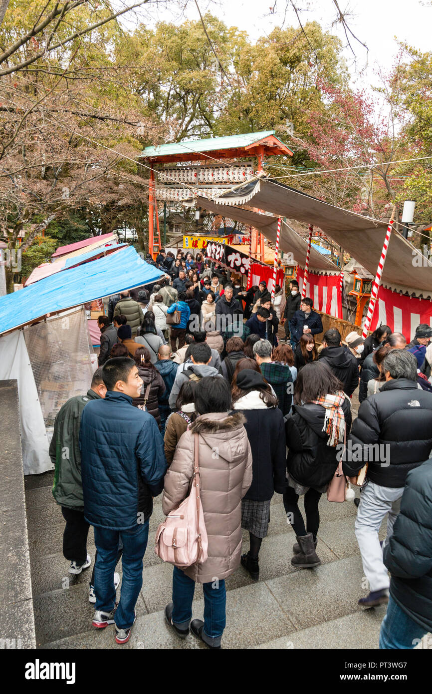 Japanese new year, Shogatsu. Avenue of market stalls, with torri gate ...