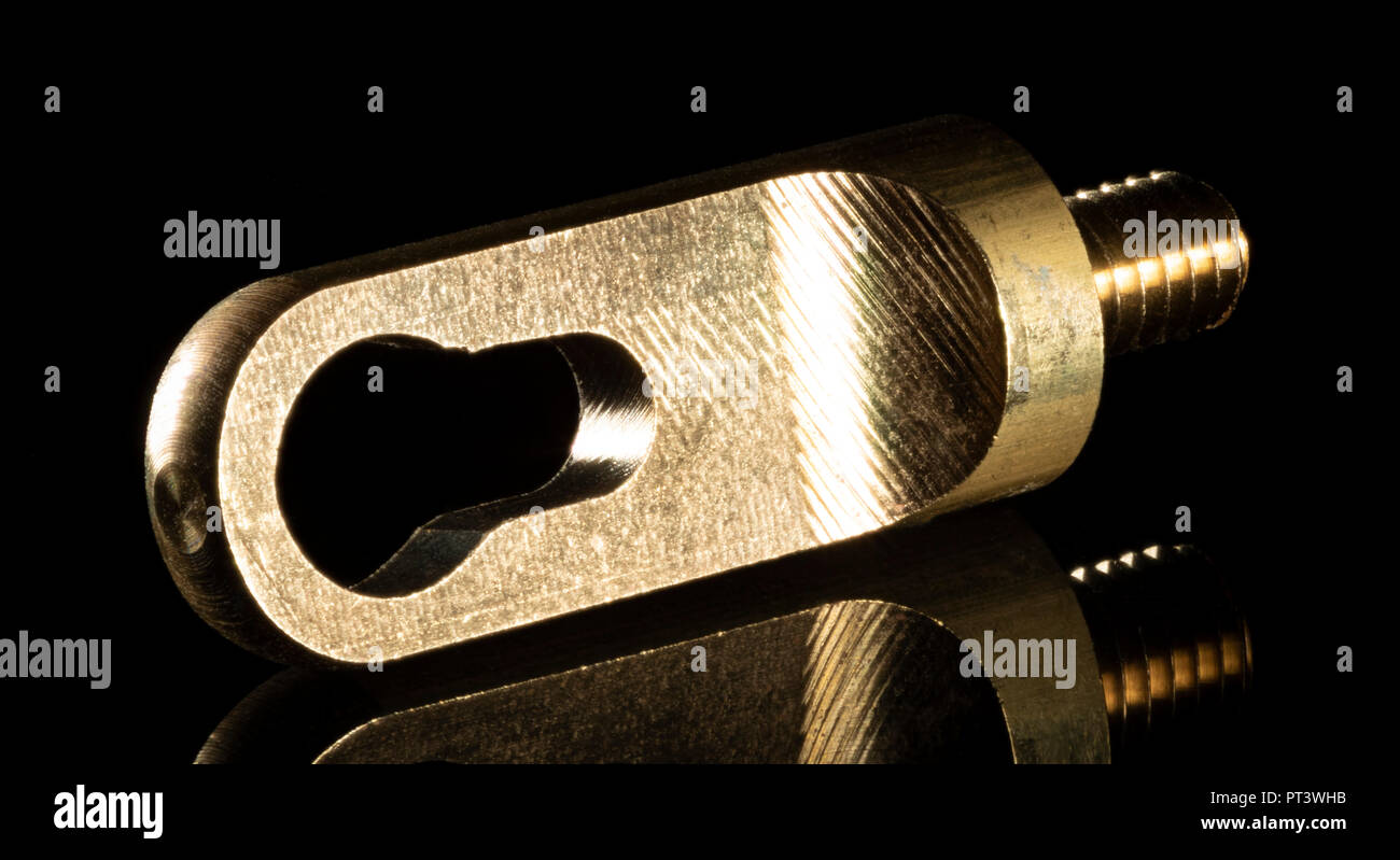 Tool used to clean a firearm on a black background with reflection ...