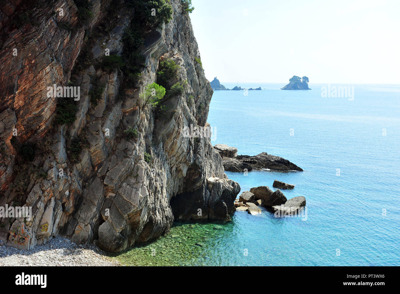 Cliff side rocks with vegetation near Adriatic ocean in Montenegro ...