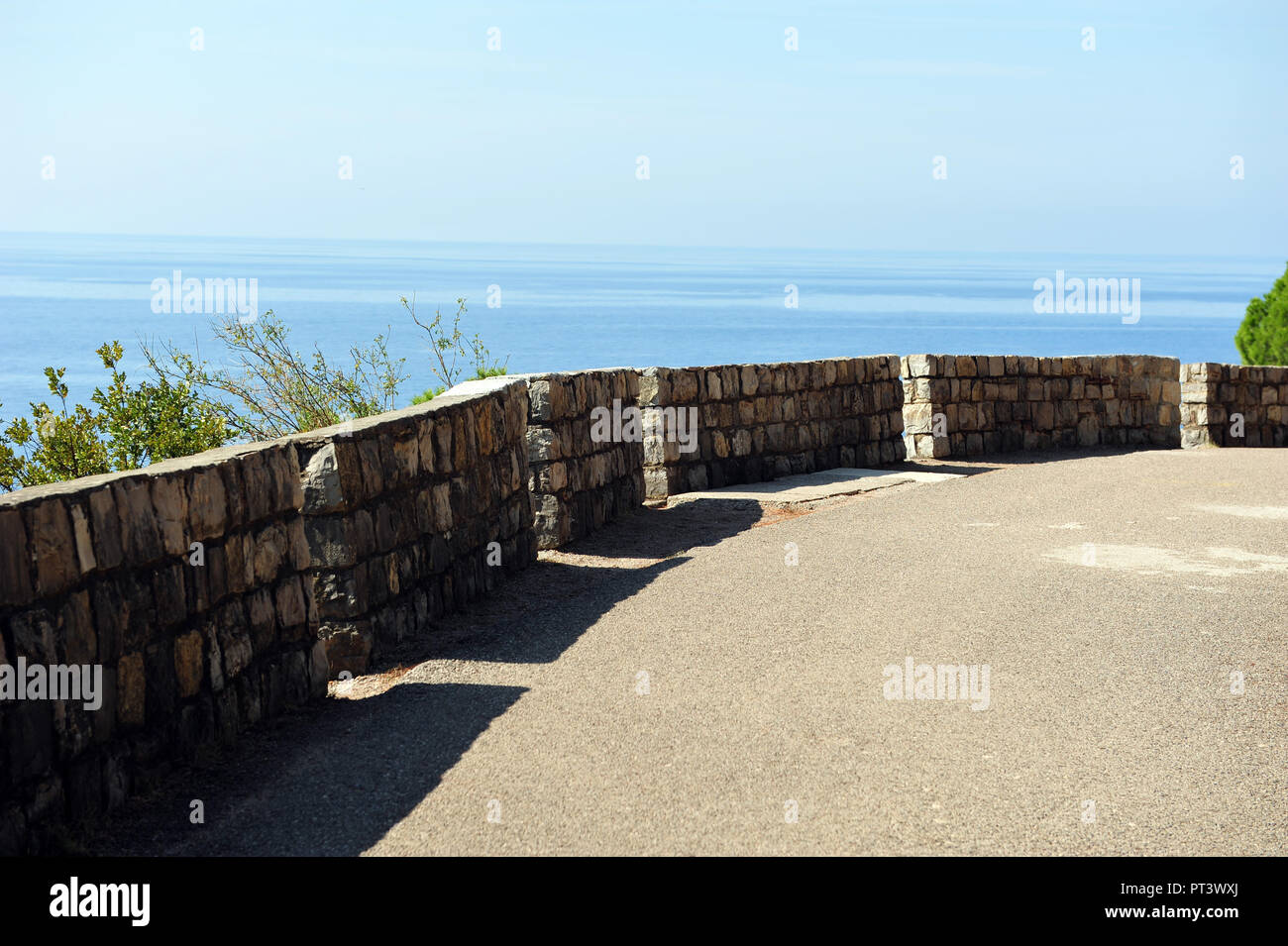 Beautiful empty walking path with partially open brick fences ...
