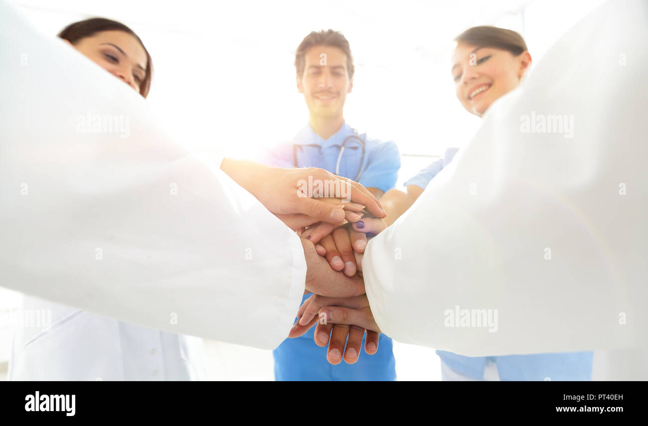 Doctors and nurses in a medical team stacking hands.concept of unity ...