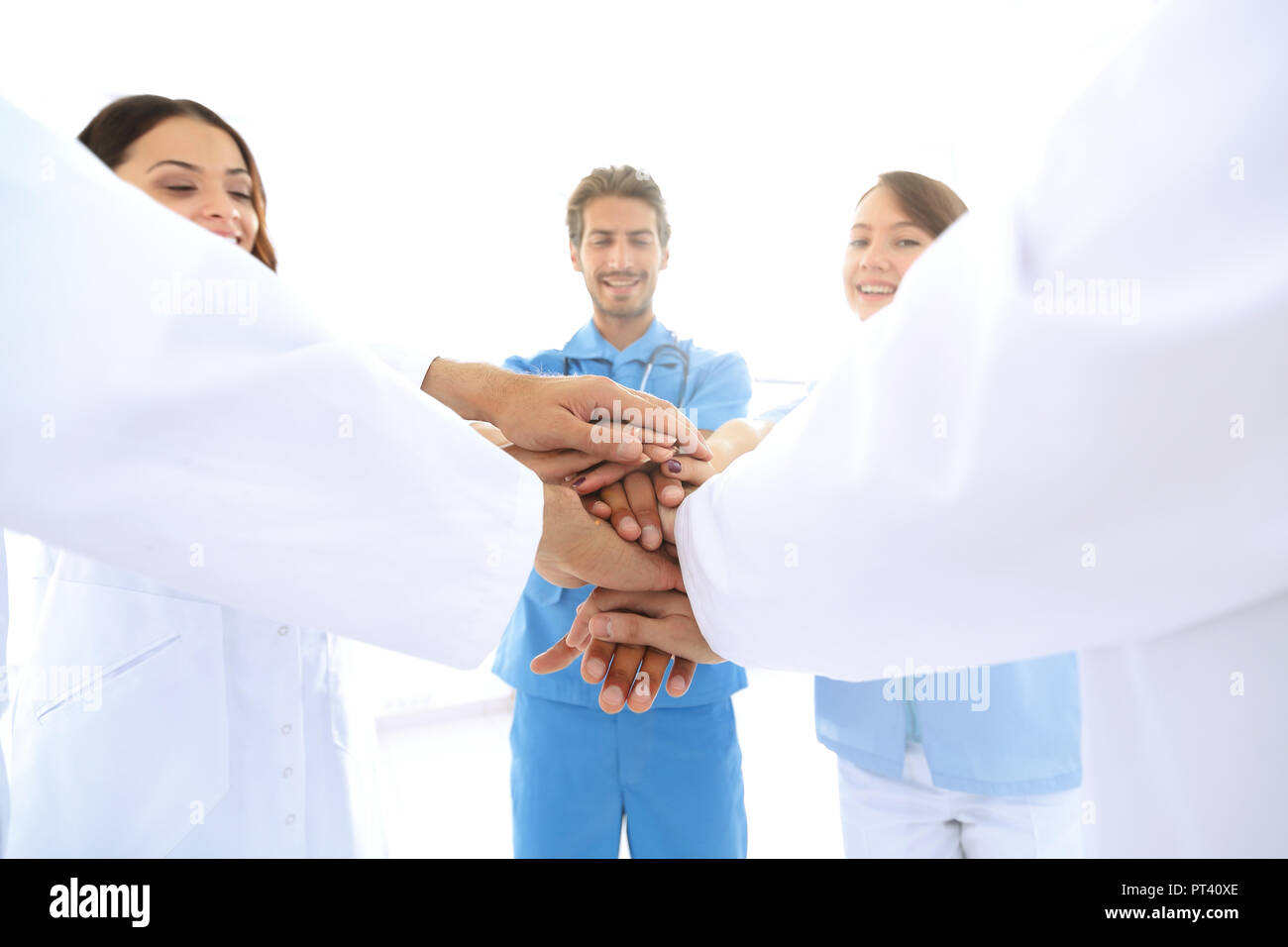 Doctors and nurses in a medical team stacking hands.concept of unity ...