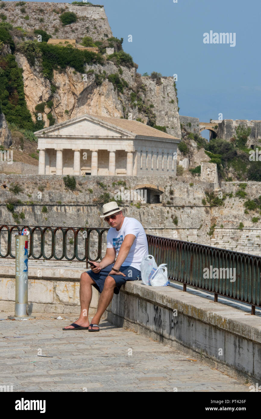 man on holiday in corfu in Greece in front of a classical greek ...