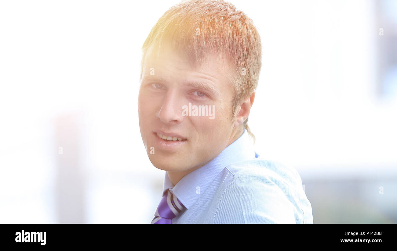 Rear View Of A Confident Young Man Looking Over His Shoulder While Sitting In The Office Stock