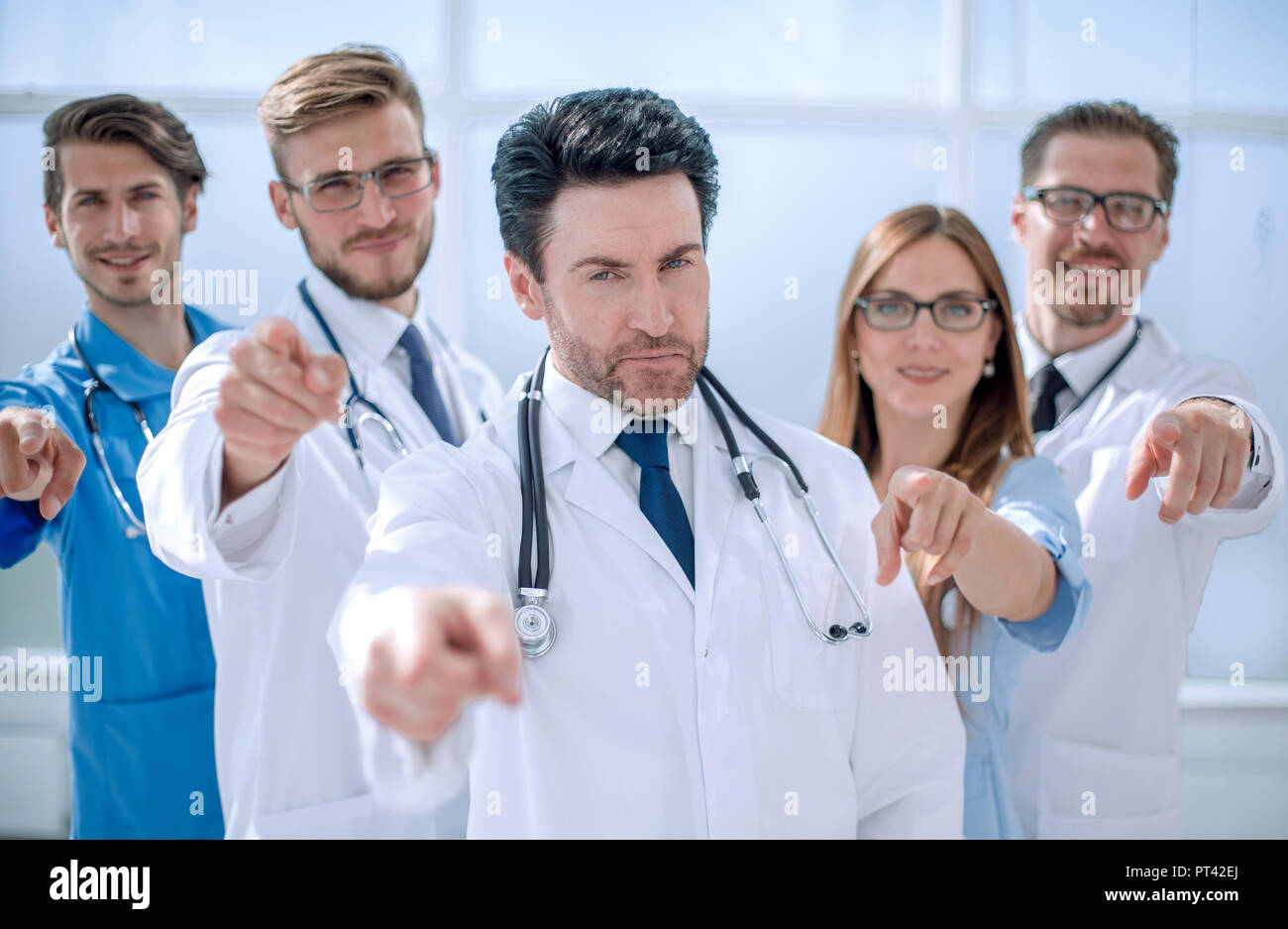 team of doctors and nurses, pointing at you .the concept of health ...