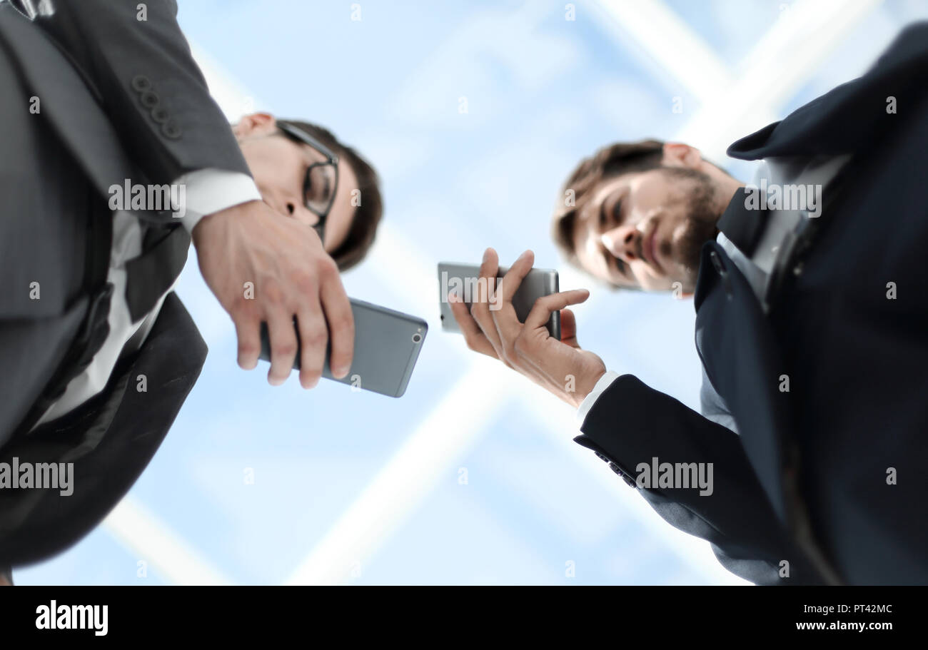two business peoples using mobile phone Stock Photo - Alamy