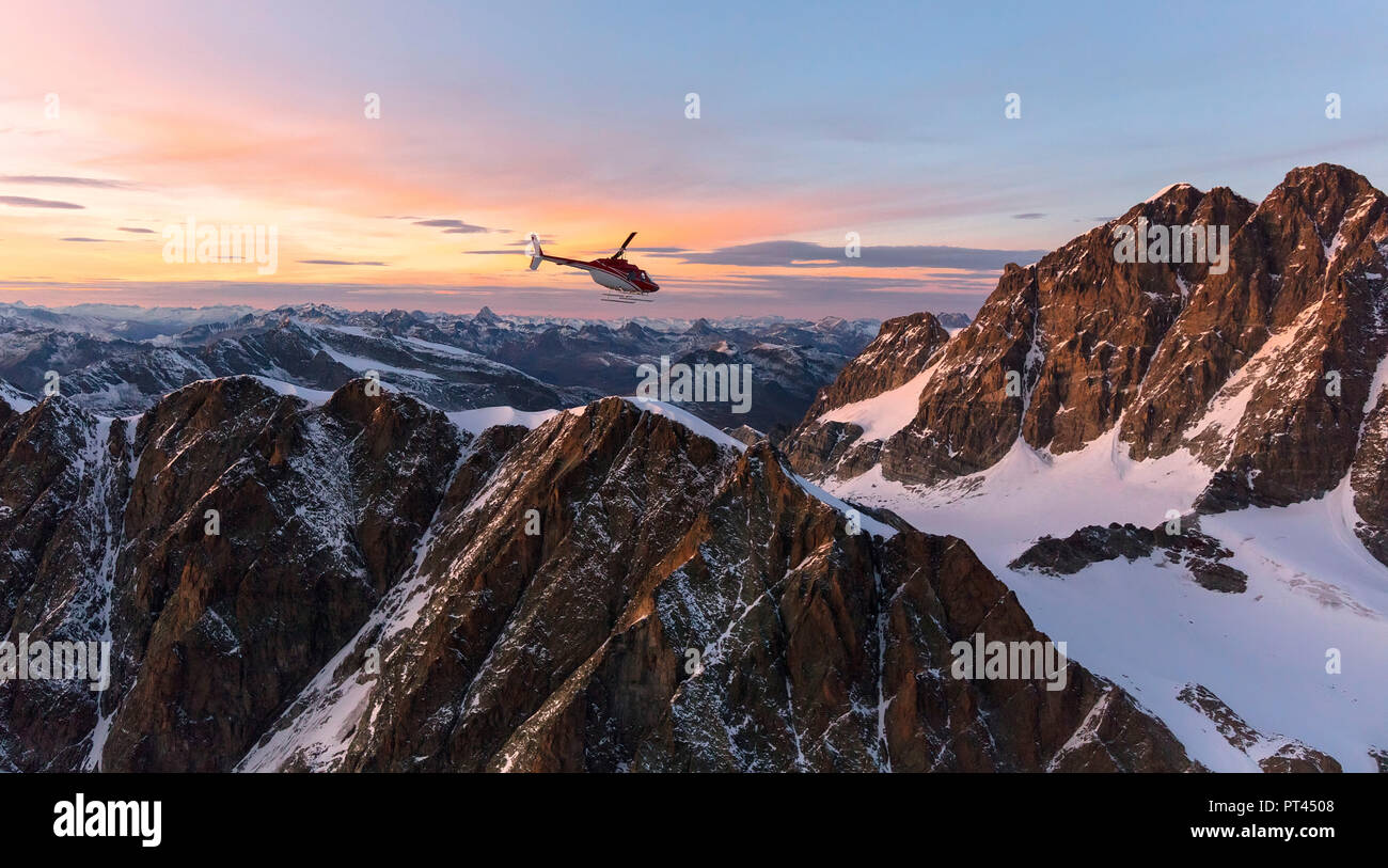 Aerial view of helicopter in flight towards Piz Roseg at sunset ...