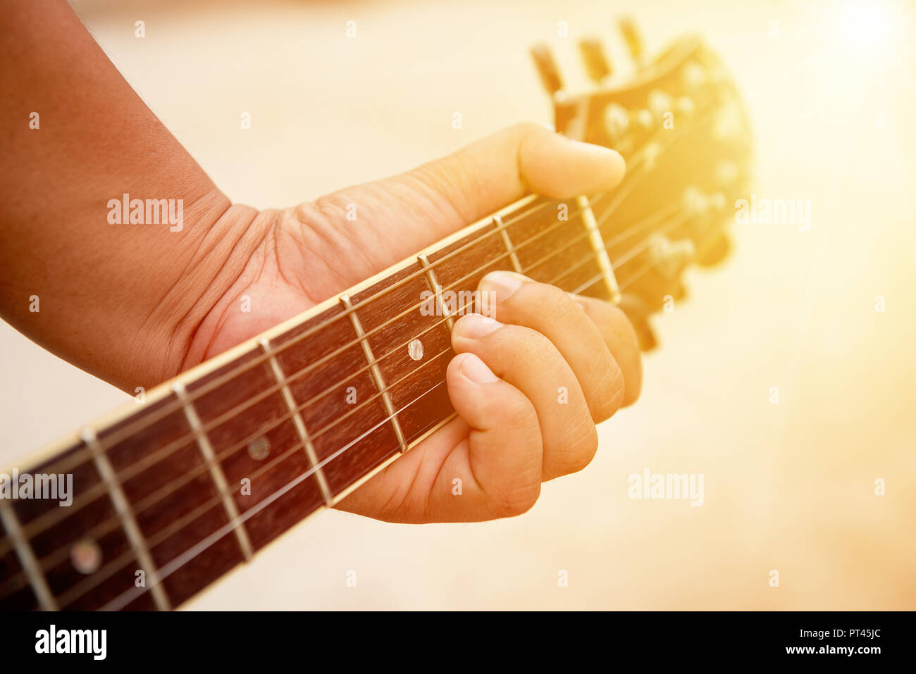 man holding guitar with sun light Stock Photo - Alamy