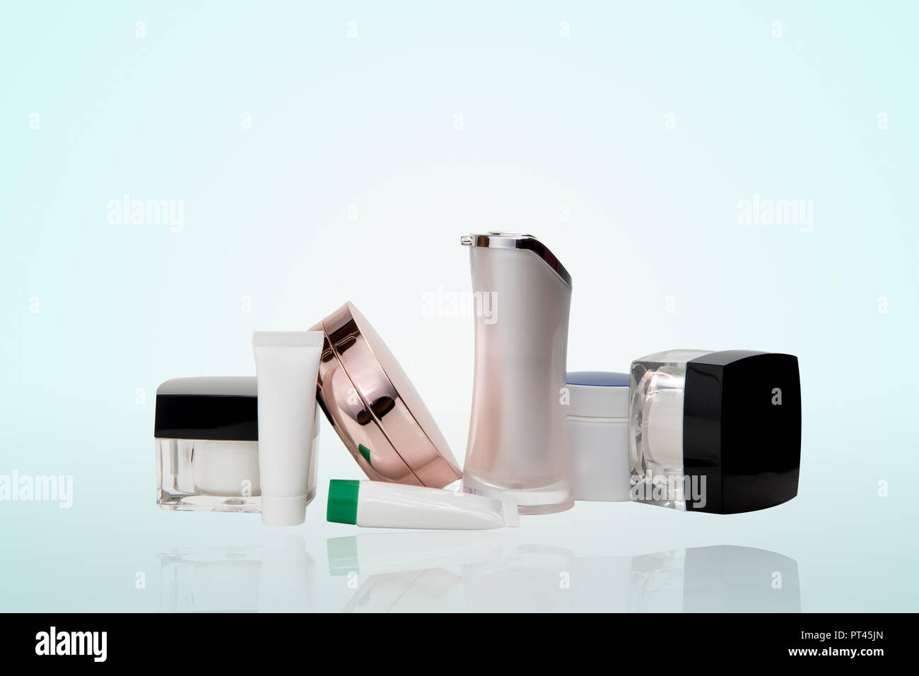 cosmetics onclear background, many cosmetic and reflection on glass ...