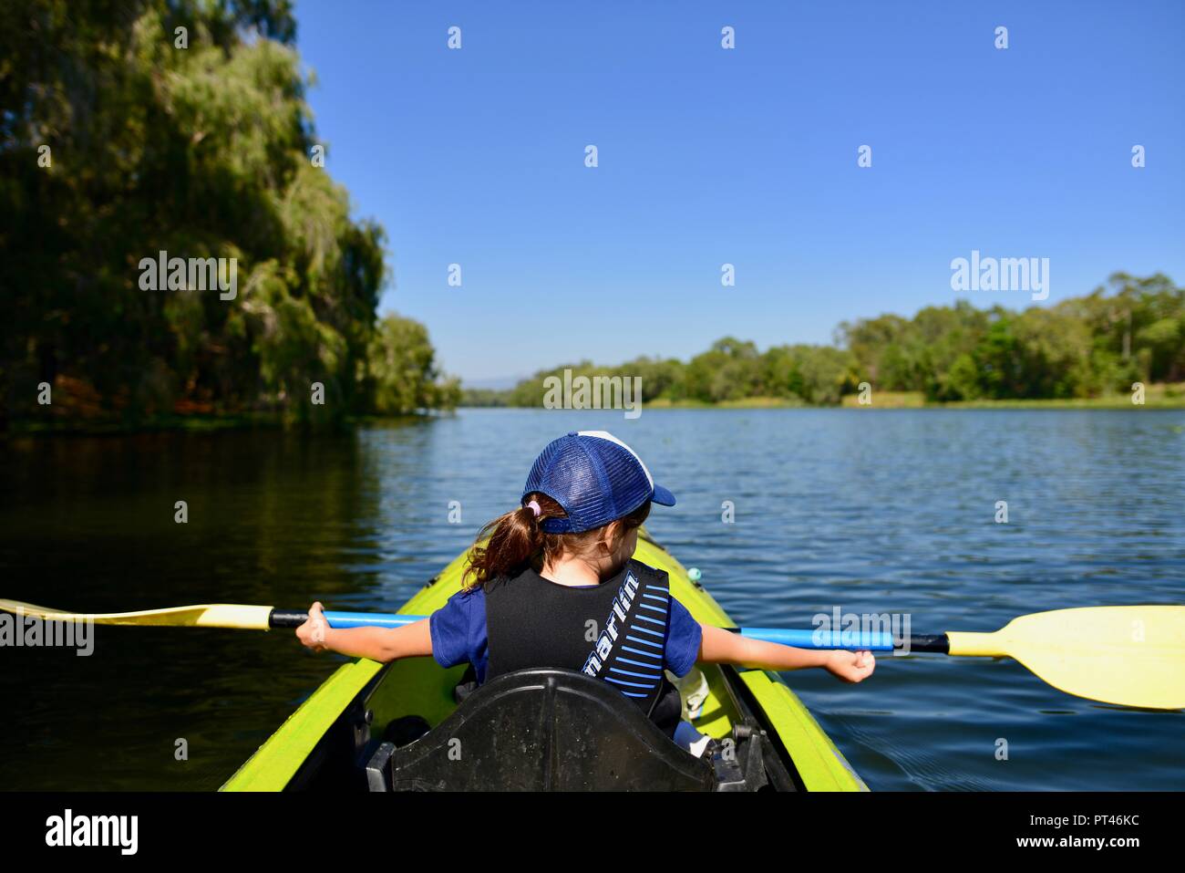 Children paddling in a canoe in beautiful weather hi-res stock ...