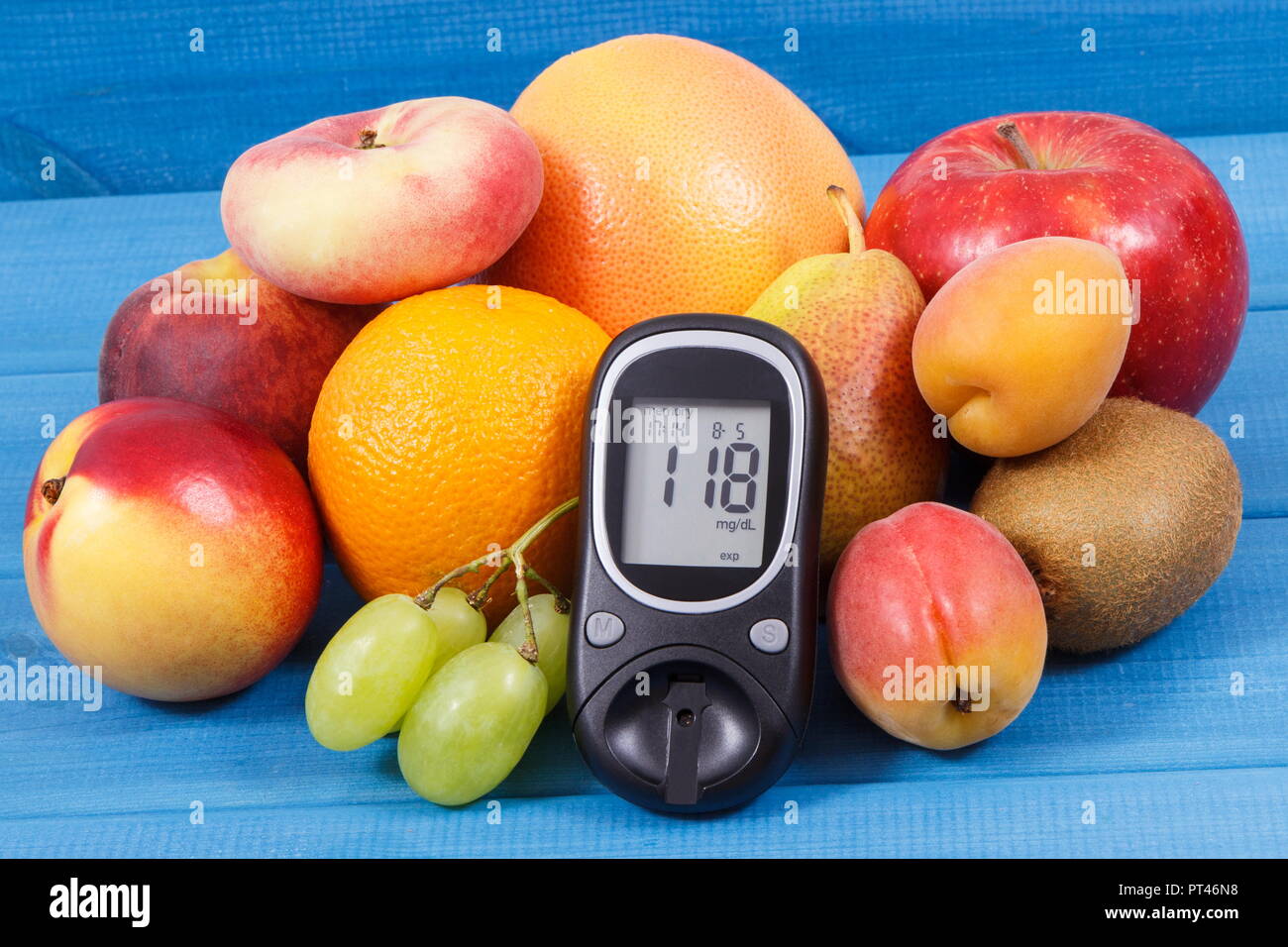 Glucometer for checking sugar level and fresh healthy food as source ...