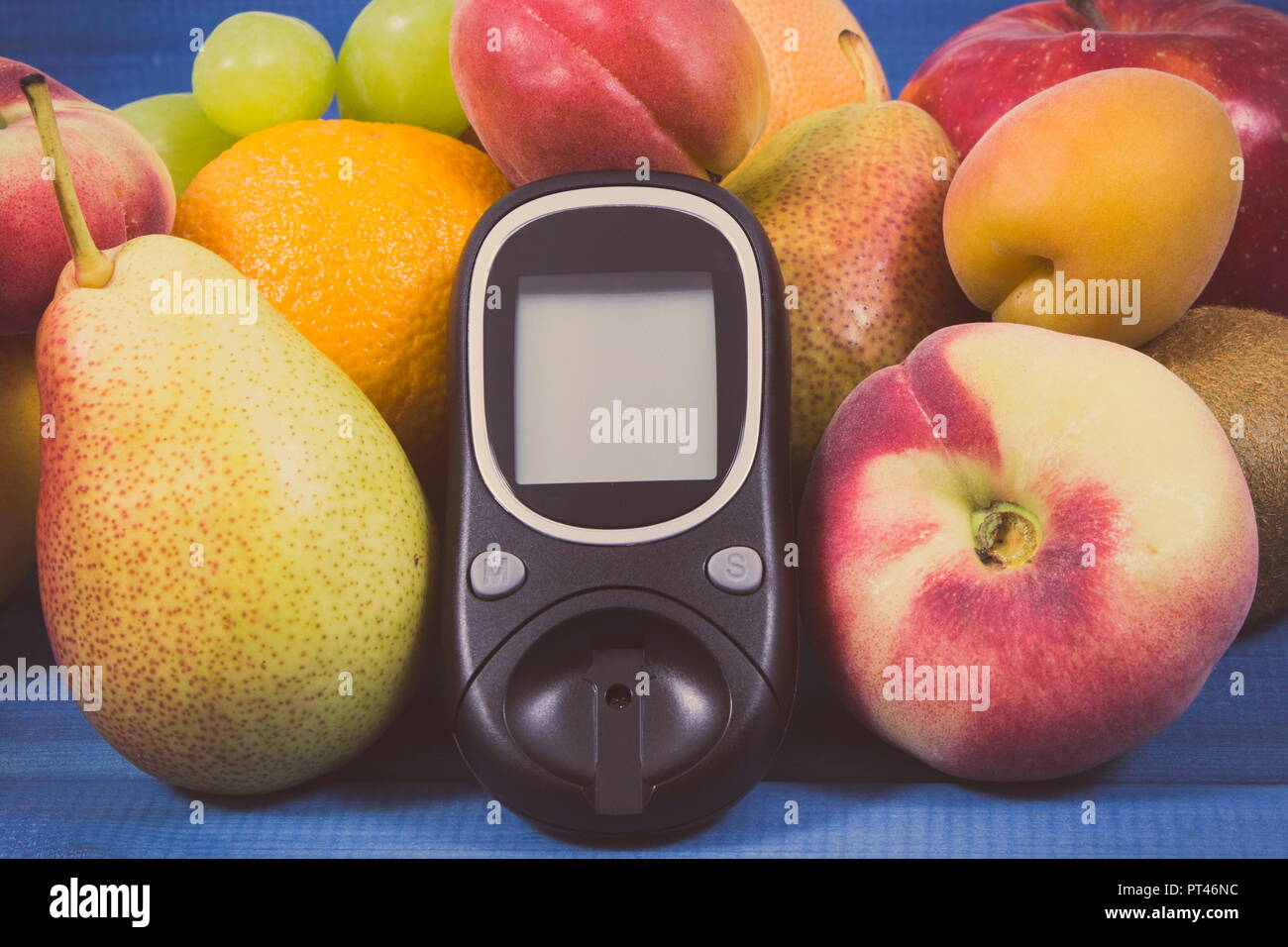 Glucometer for checking sugar level and fresh healthy food as source ...