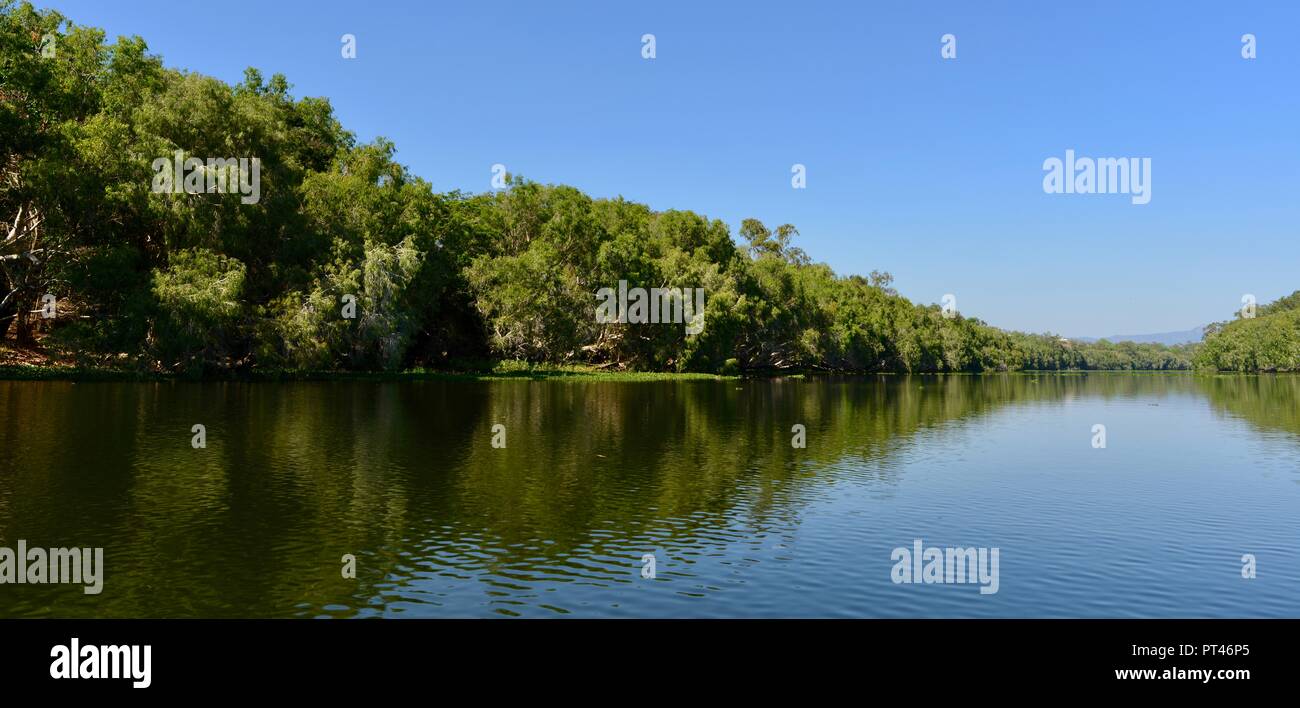 Children paddling in a canoe in beautiful weather, Ross River QLD ...