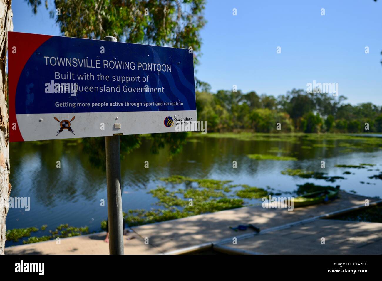 Children paddling in a canoe in beautiful weather, Ross River QLD ...