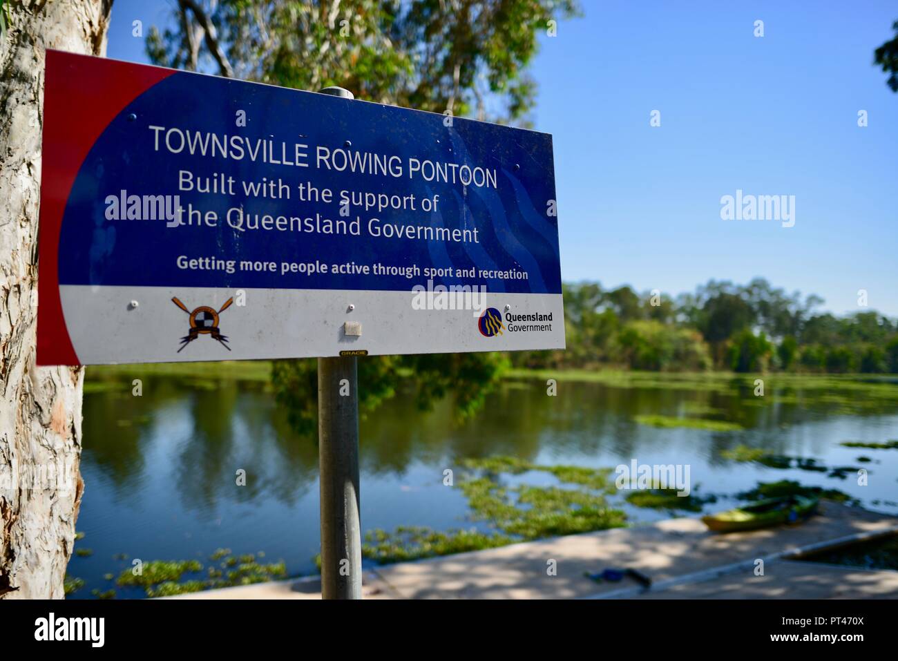 Children paddling in a canoe in beautiful weather, Ross River QLD ...
