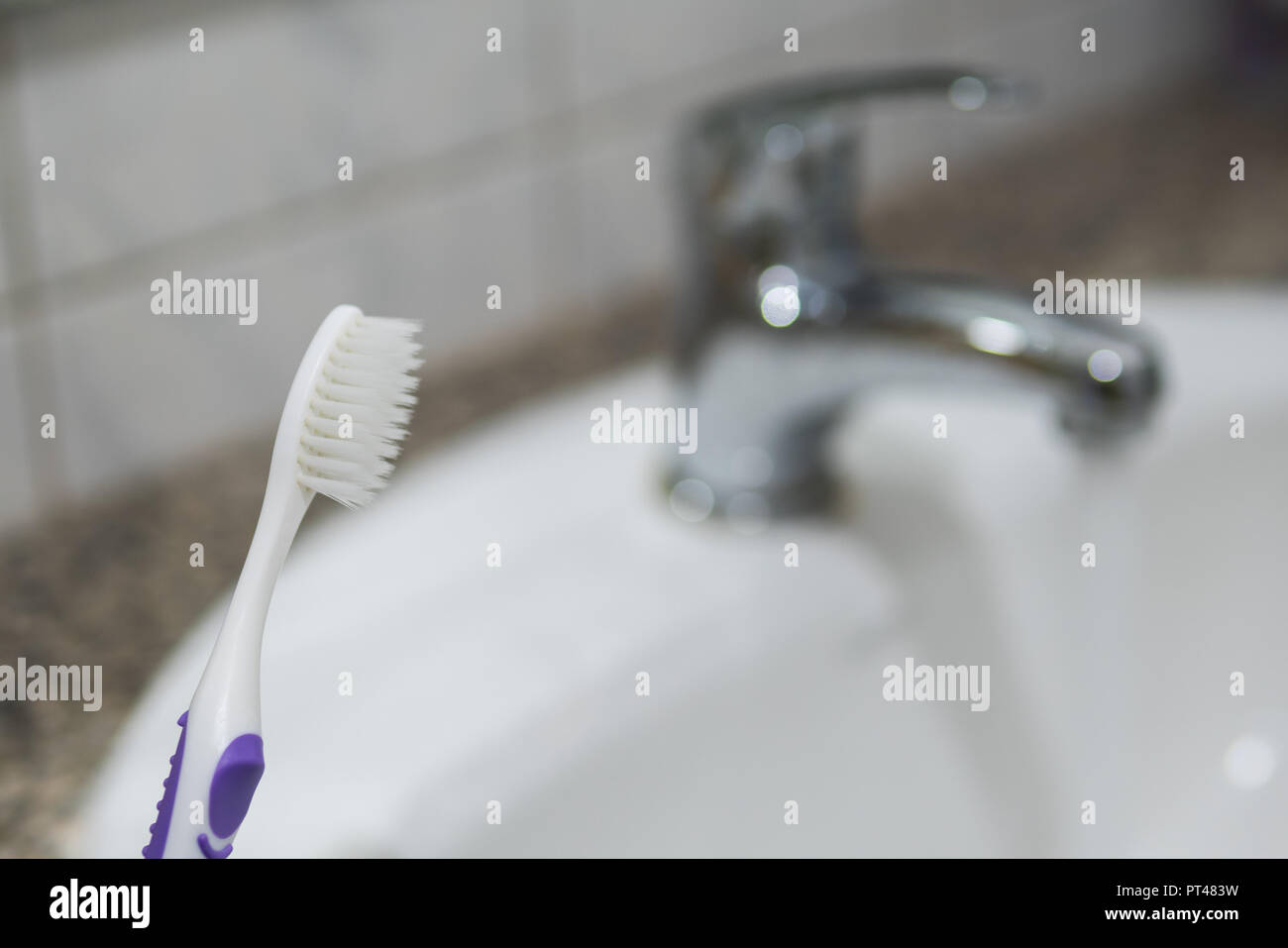Toothbrush with bathroom sink Stock Photo - Alamy