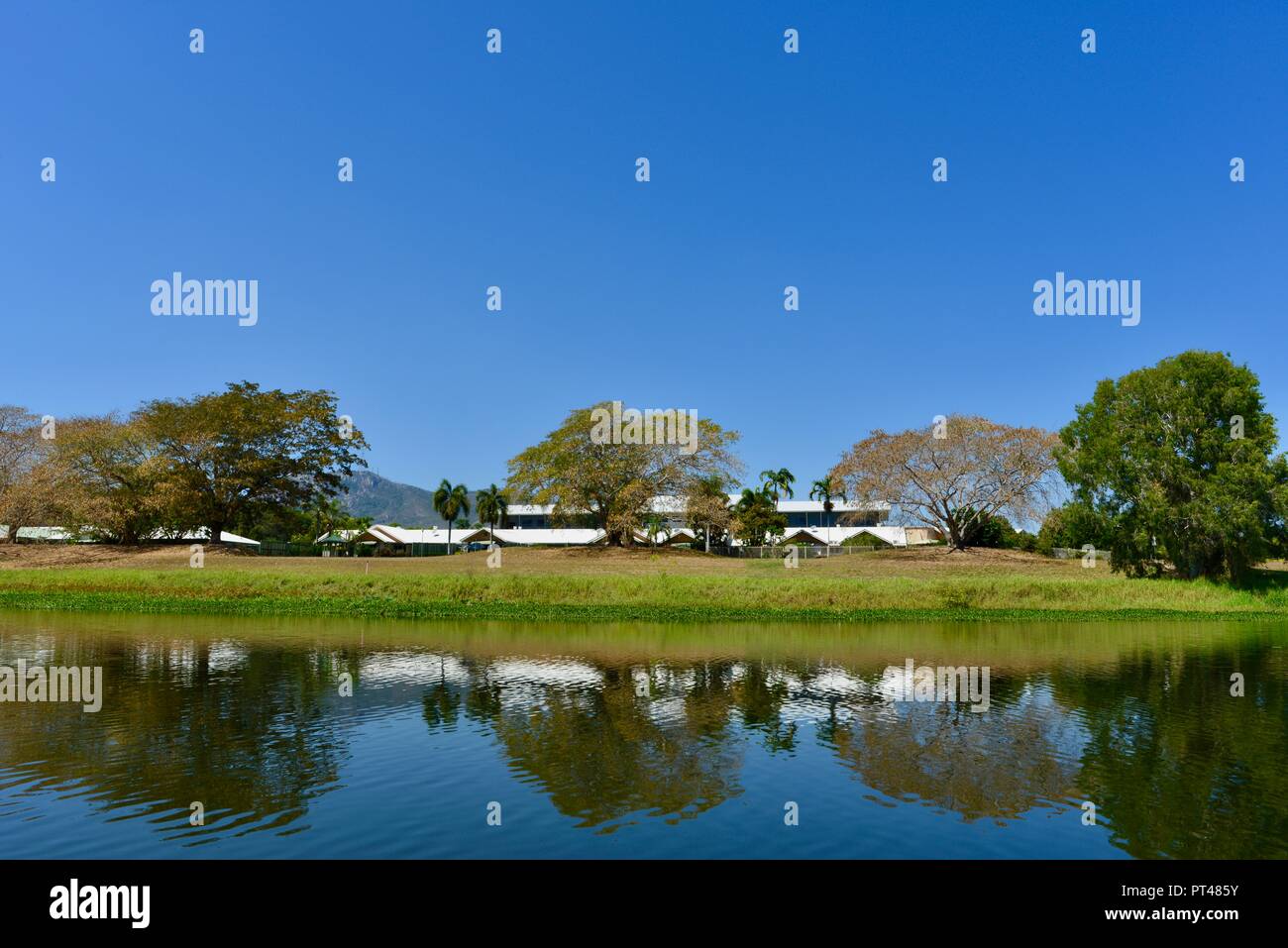Children paddling in a canoe in beautiful weather, Ross River QLD ...