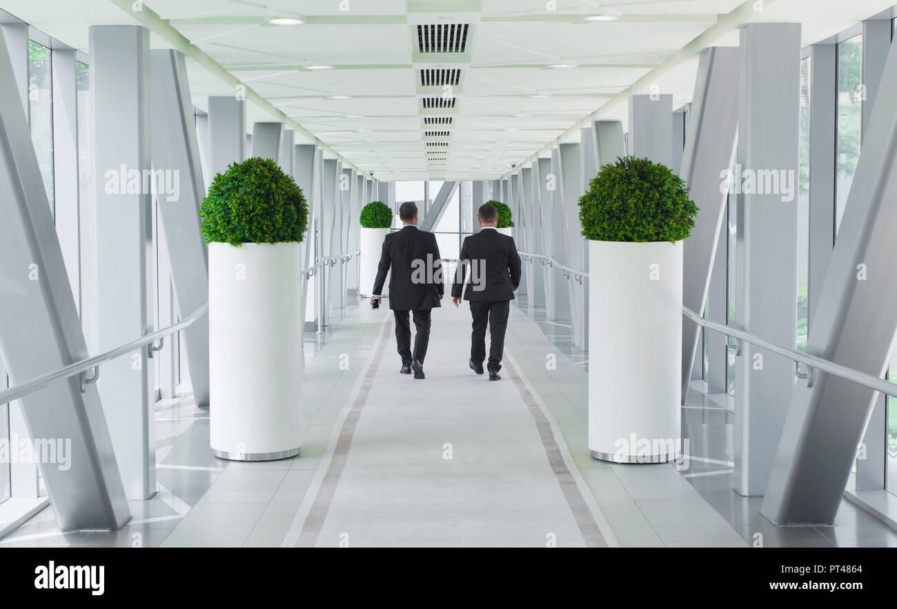 two business men people walking in modern building, vision or success ...