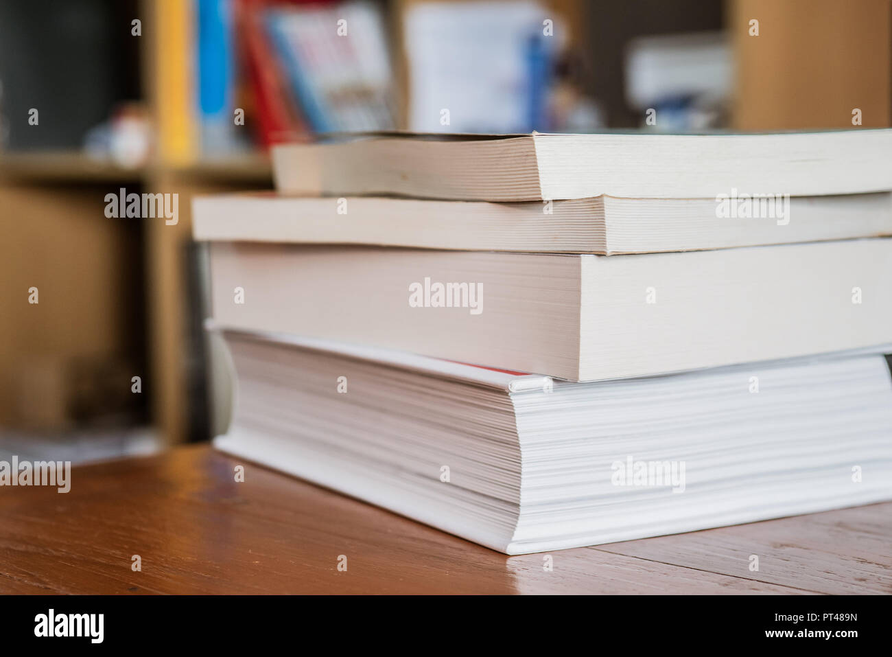 Books on a table in library Stock Photo - Alamy