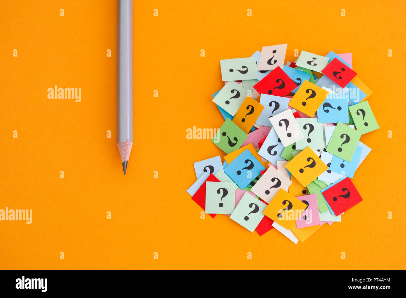 Pencil and question marks on yellow background. Concept image. Close up ...