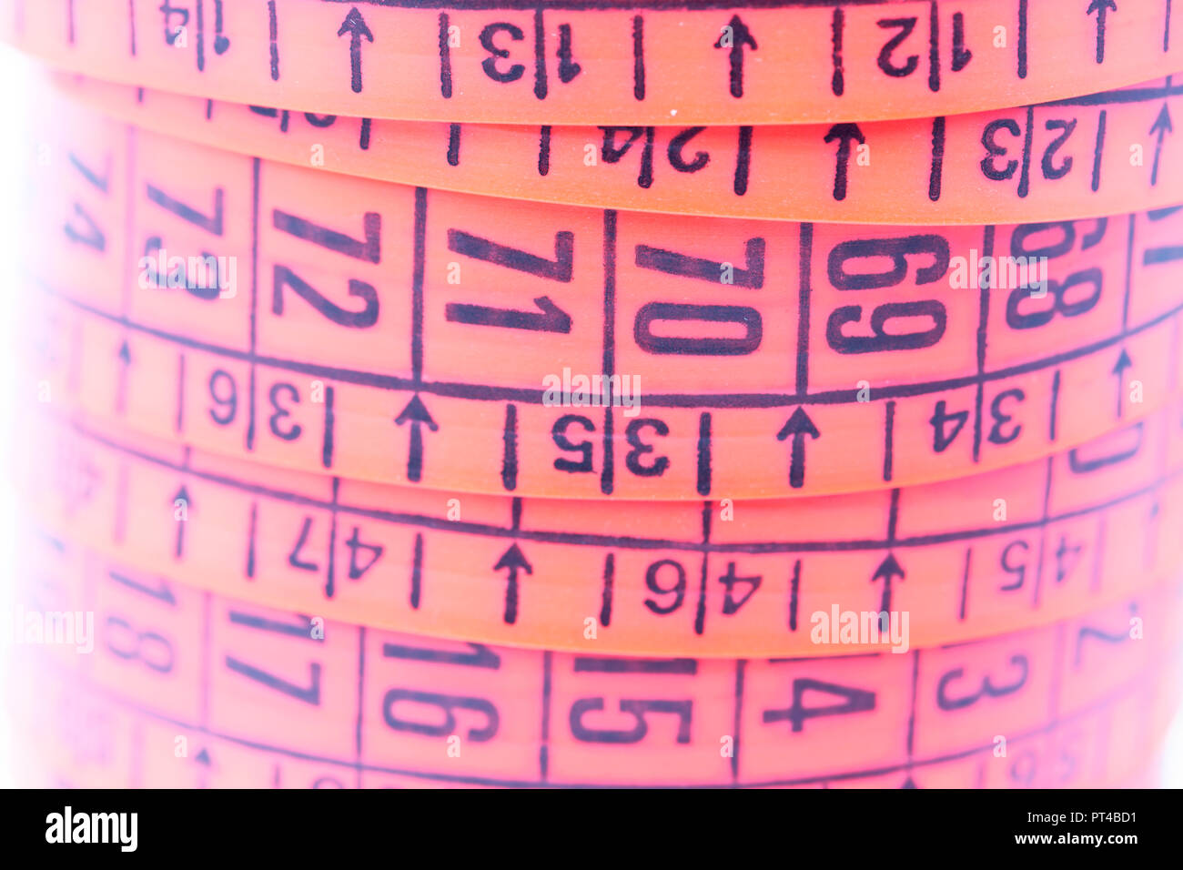 in the white light rotation of a red measure tape like concept measure ...