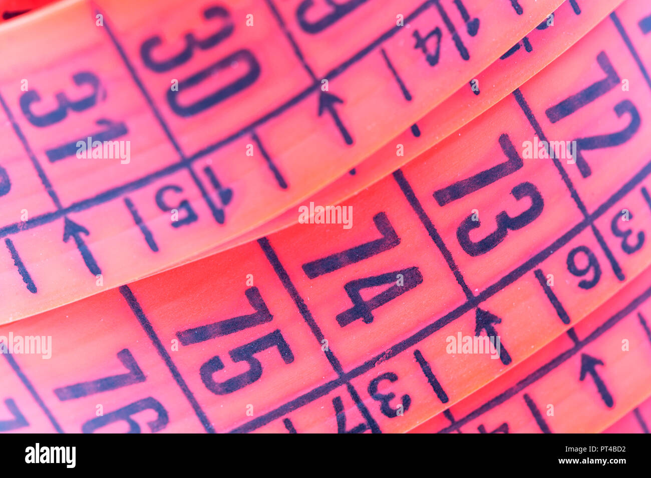 in the white light rotation of a red measure tape like concept measure ...