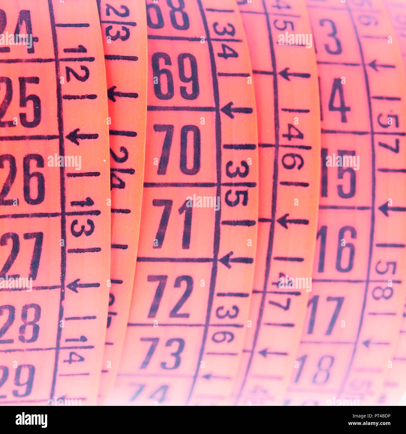 in the white light rotation of a red measure tape like concept measure ...