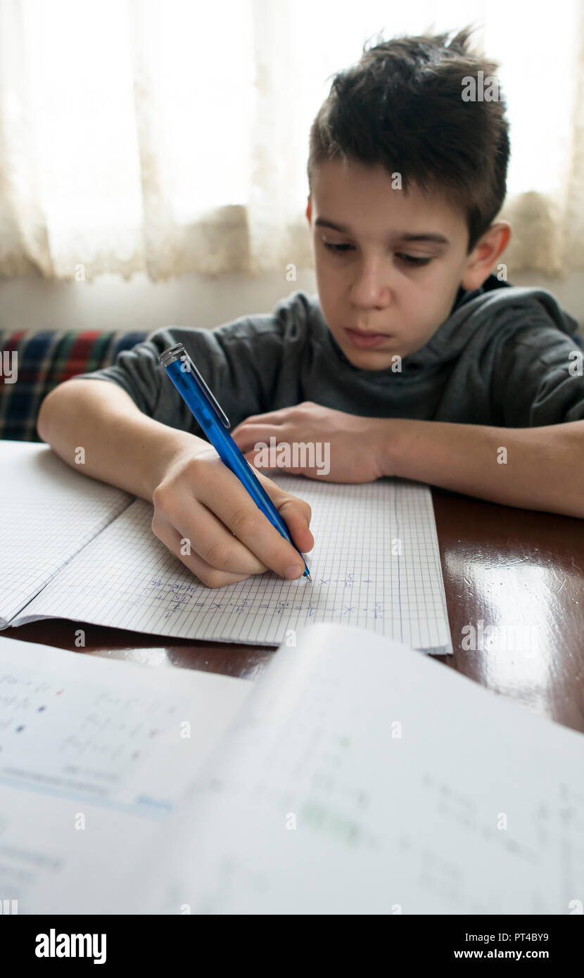 Boy do his homework. Notebook Stock Photo - Alamy