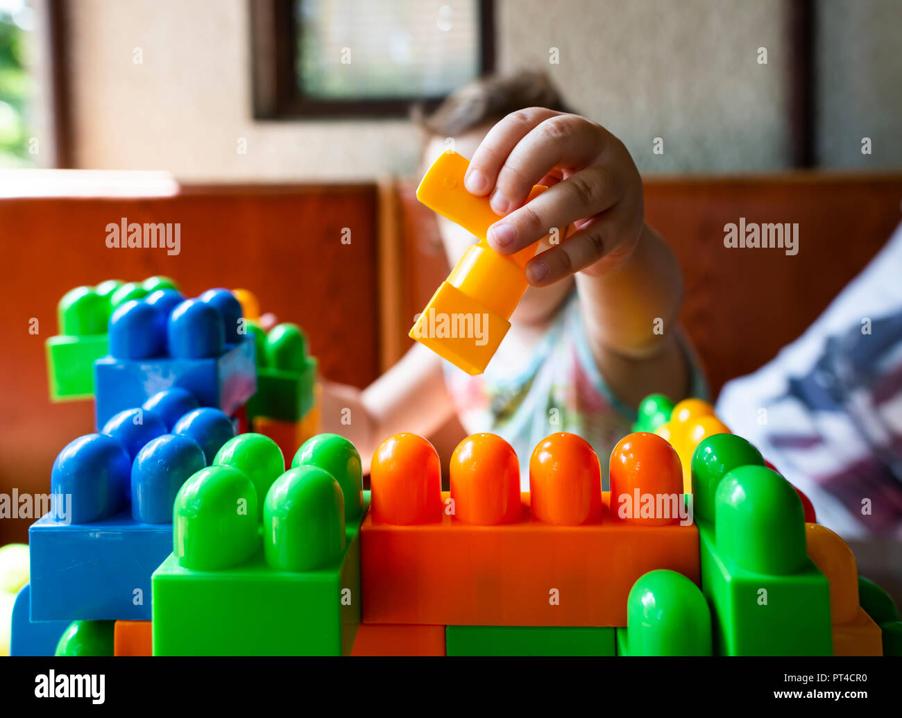 Child playing with cubes. Puts a cube Stock Photo - Alamy