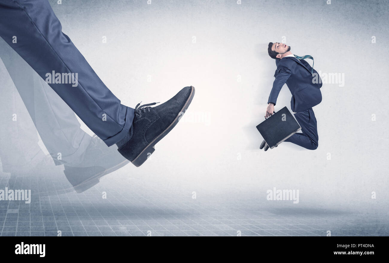 Businessman big foot kicking small, young businessman who is flying ...