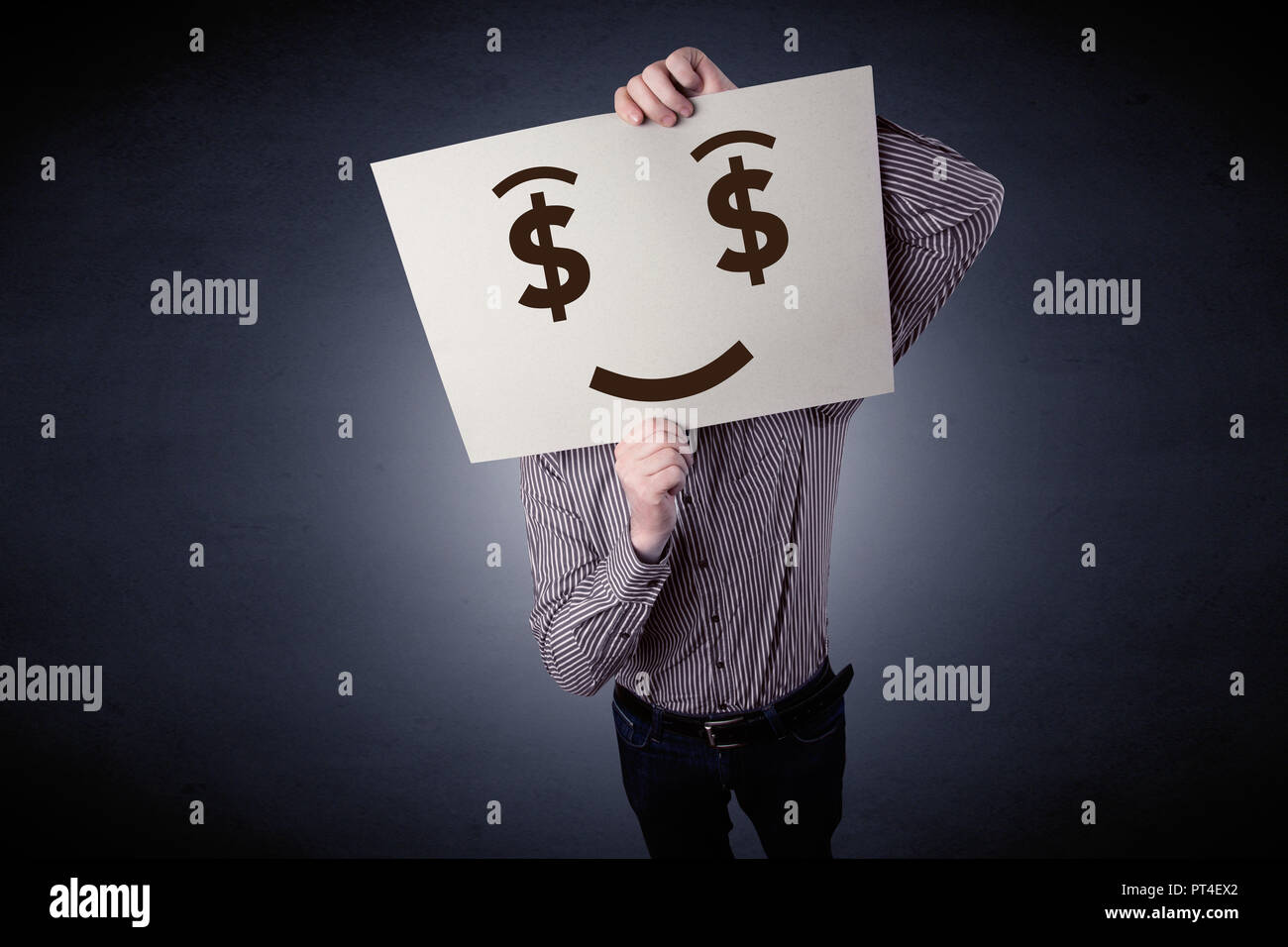 Young casual businessman hiding behind a greedy face drawing on ...