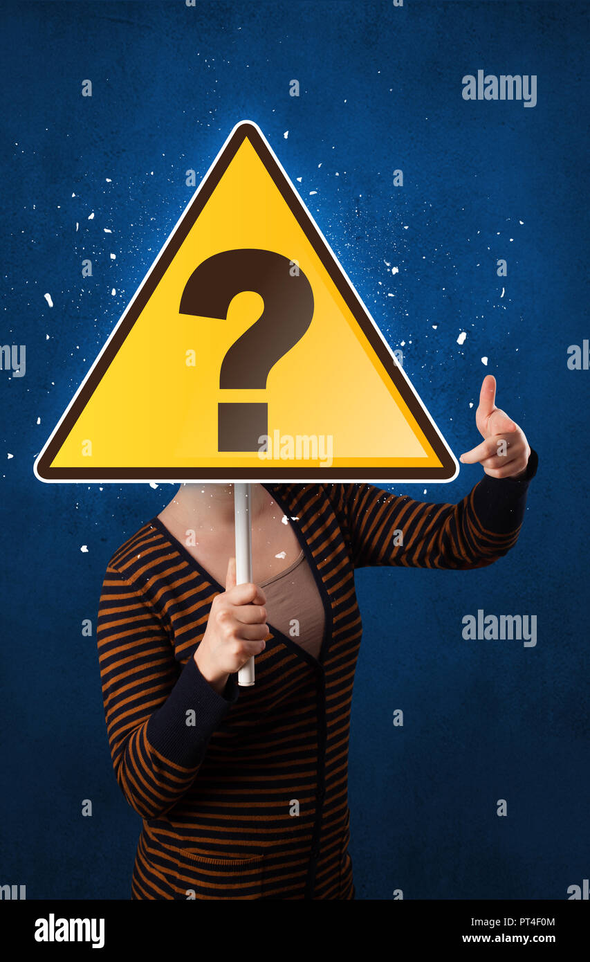 Casual young woman holding yellow sign with question mark Stock Photo ...
