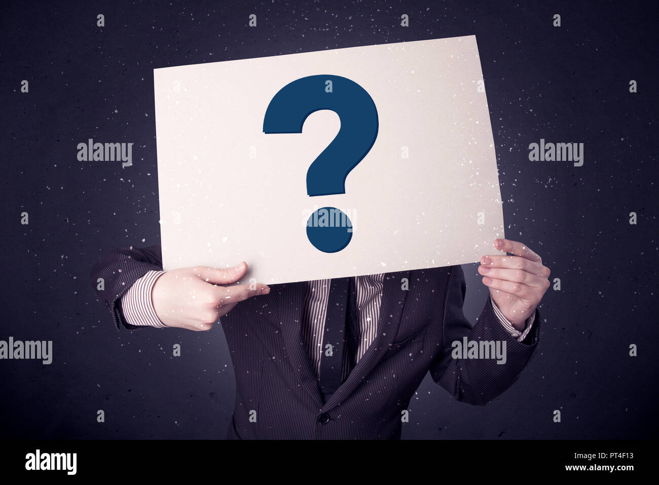 Young businessman hiding behind a question mark drawn on paper Stock ...