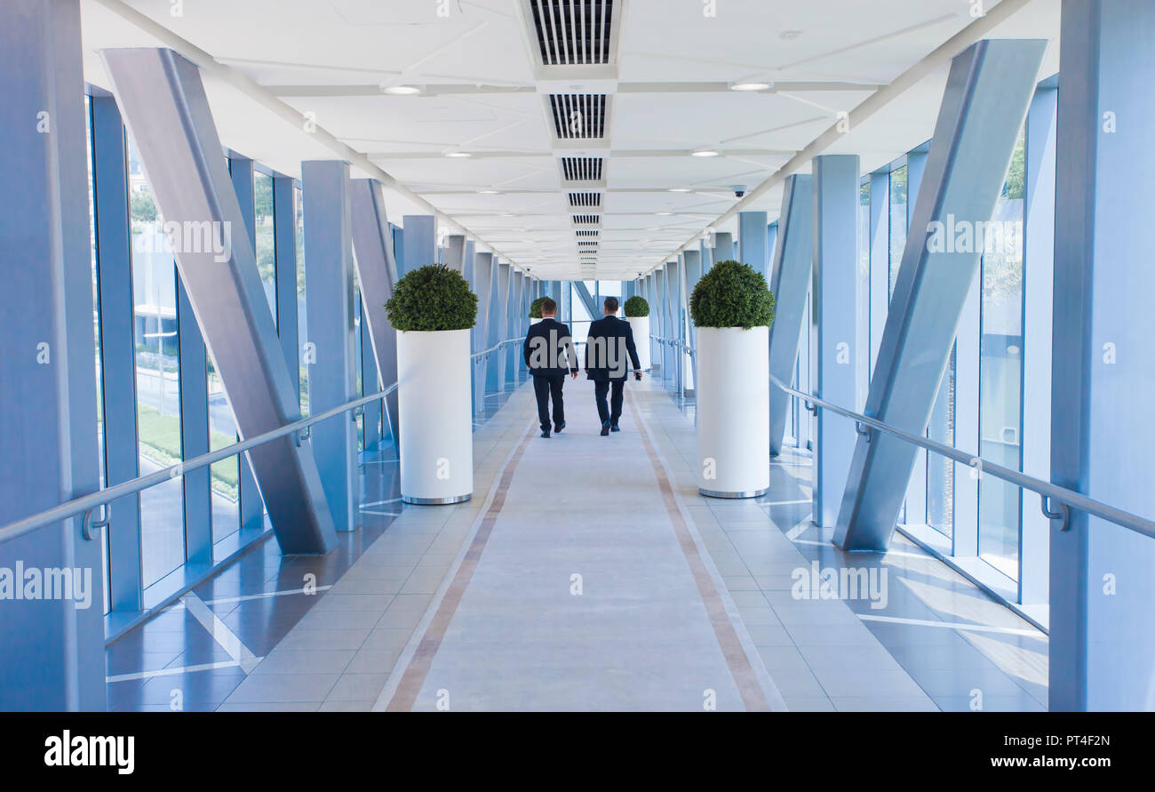 two business men people walking in modern building, vision or success ...