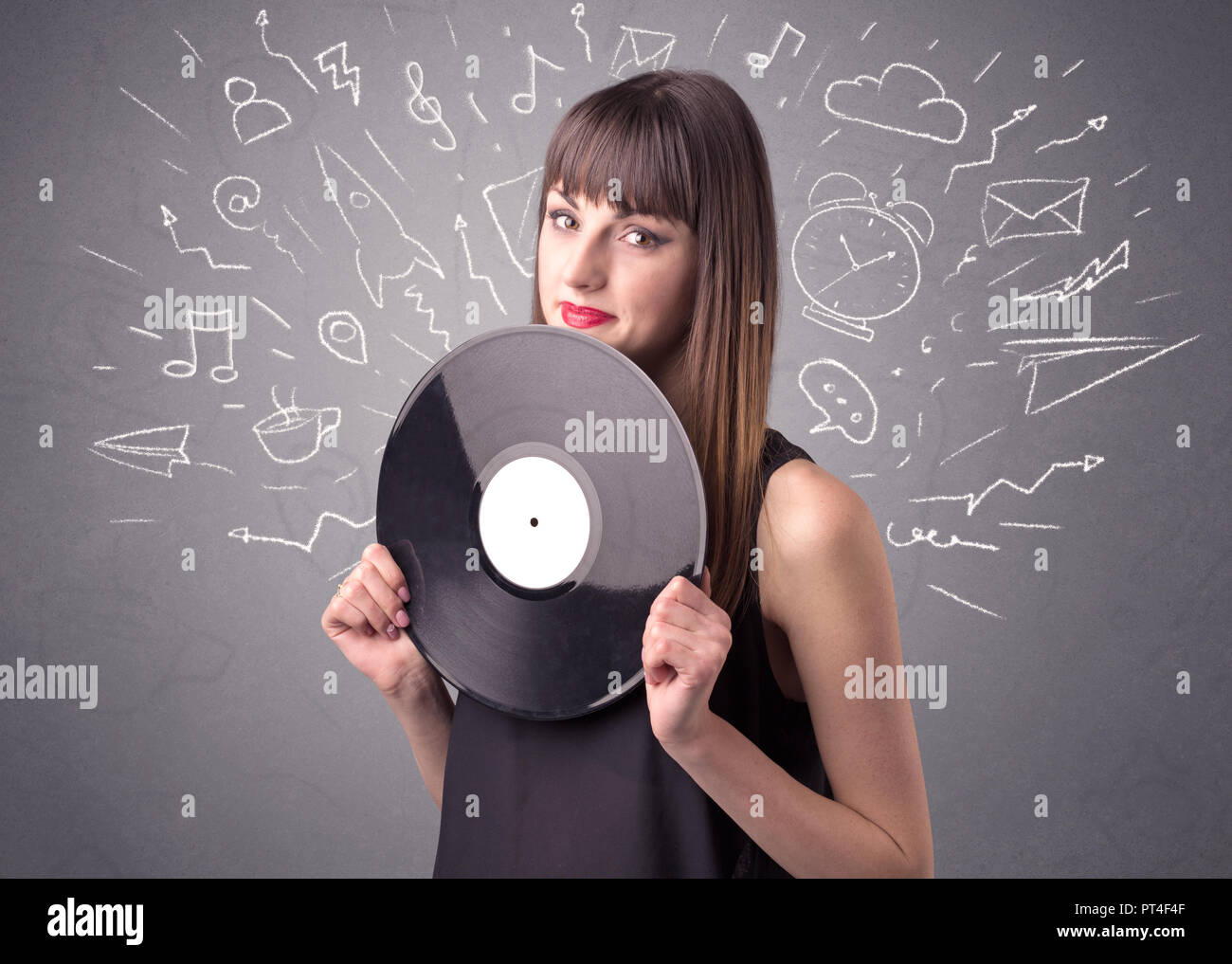 Young lady holding vinyl record on a grey background with mixed ...