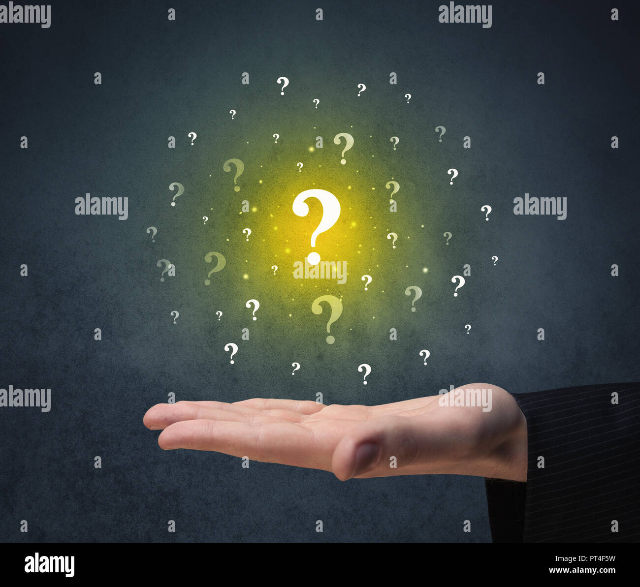 Yellow question marks hovering over young hand Stock Photo - Alamy