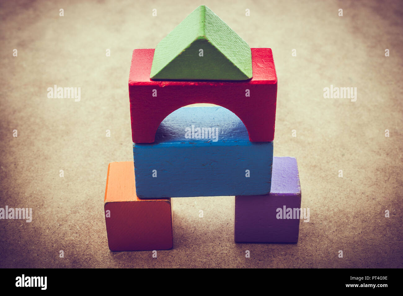 House shape formed out of building blocks on a brown background Stock ...