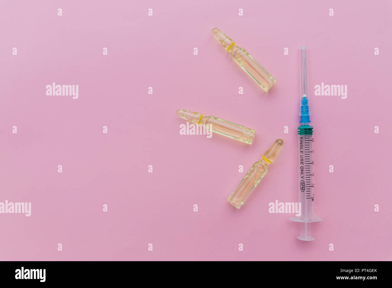 Beauty Injection, facial skin lifting on pink background concept.Glass ...