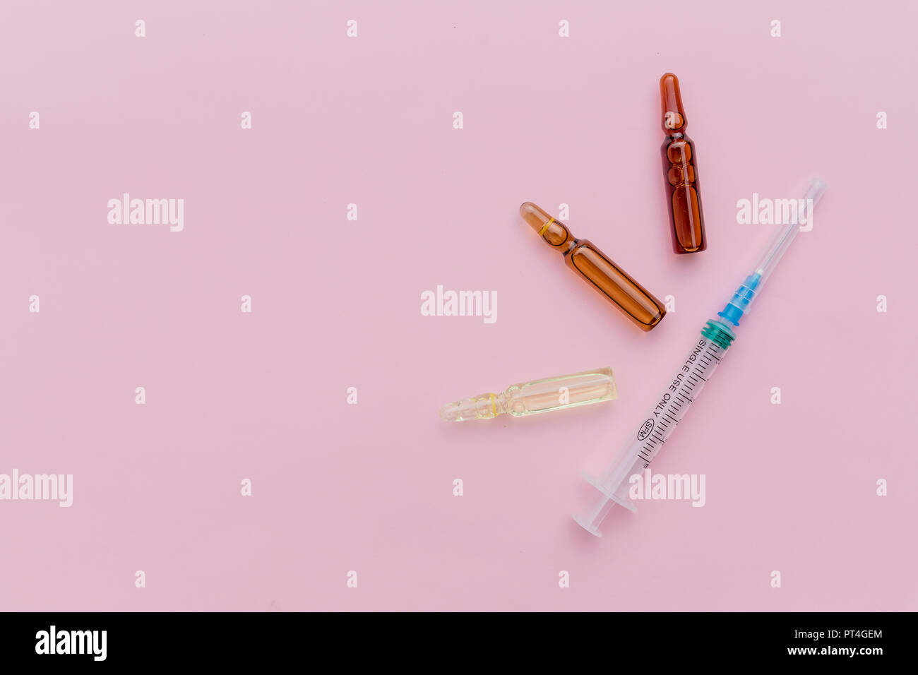 Beauty Injection, facial skin lifting on pink background concept.Glass ...