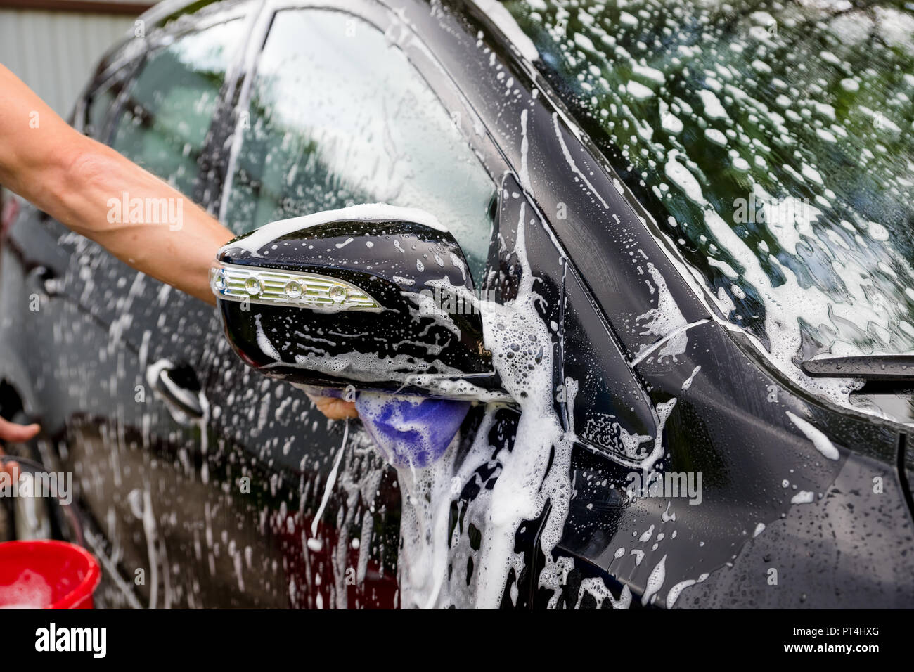 Cleaning automobile Using High Pressure Water. Man washing his car ...