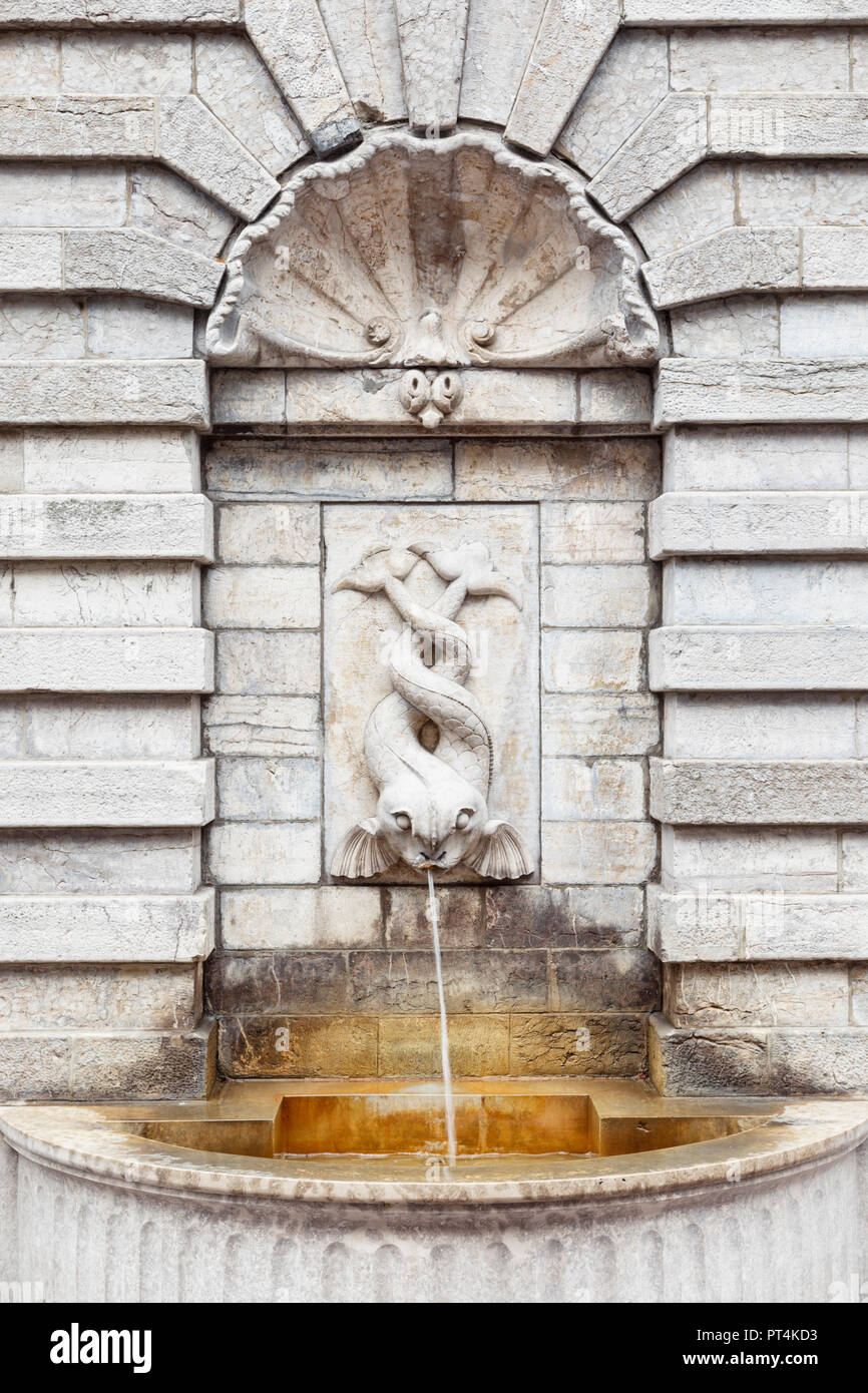 Ornate fountain with two-tailed fish at the fortified city of Boulogne ...