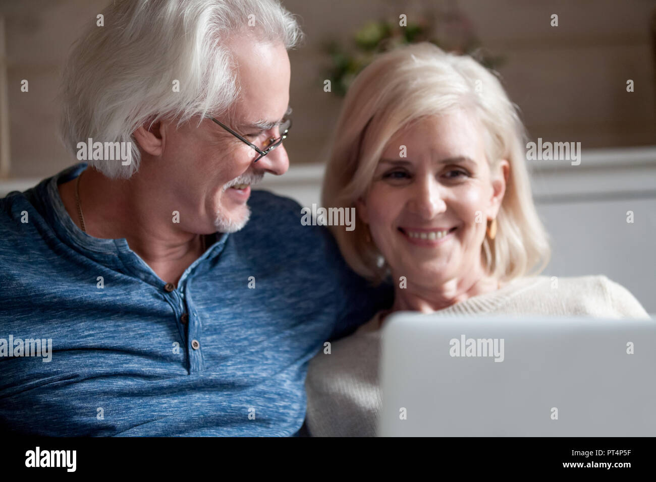 Loving couple using laptop together hi-res stock photography and images ...