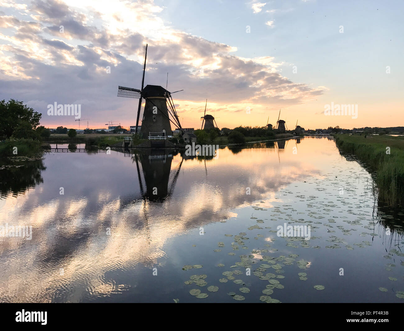Beautiful dutch windmill landscape at the famous Kinderdijk canals, UNESCO world heritage site ...